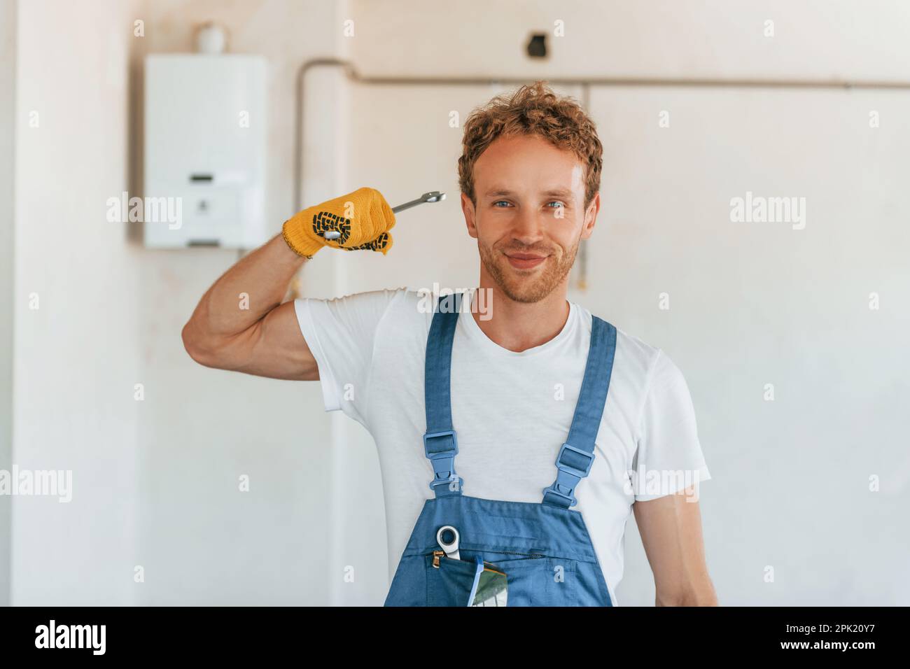 Job is done. Young man working in uniform at construction at daytime ...