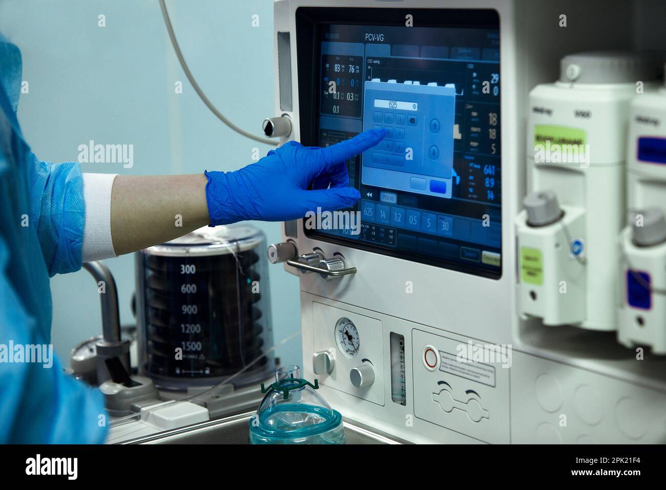 The doctor's hand operates a heart rate monitor in a hospital theater ...