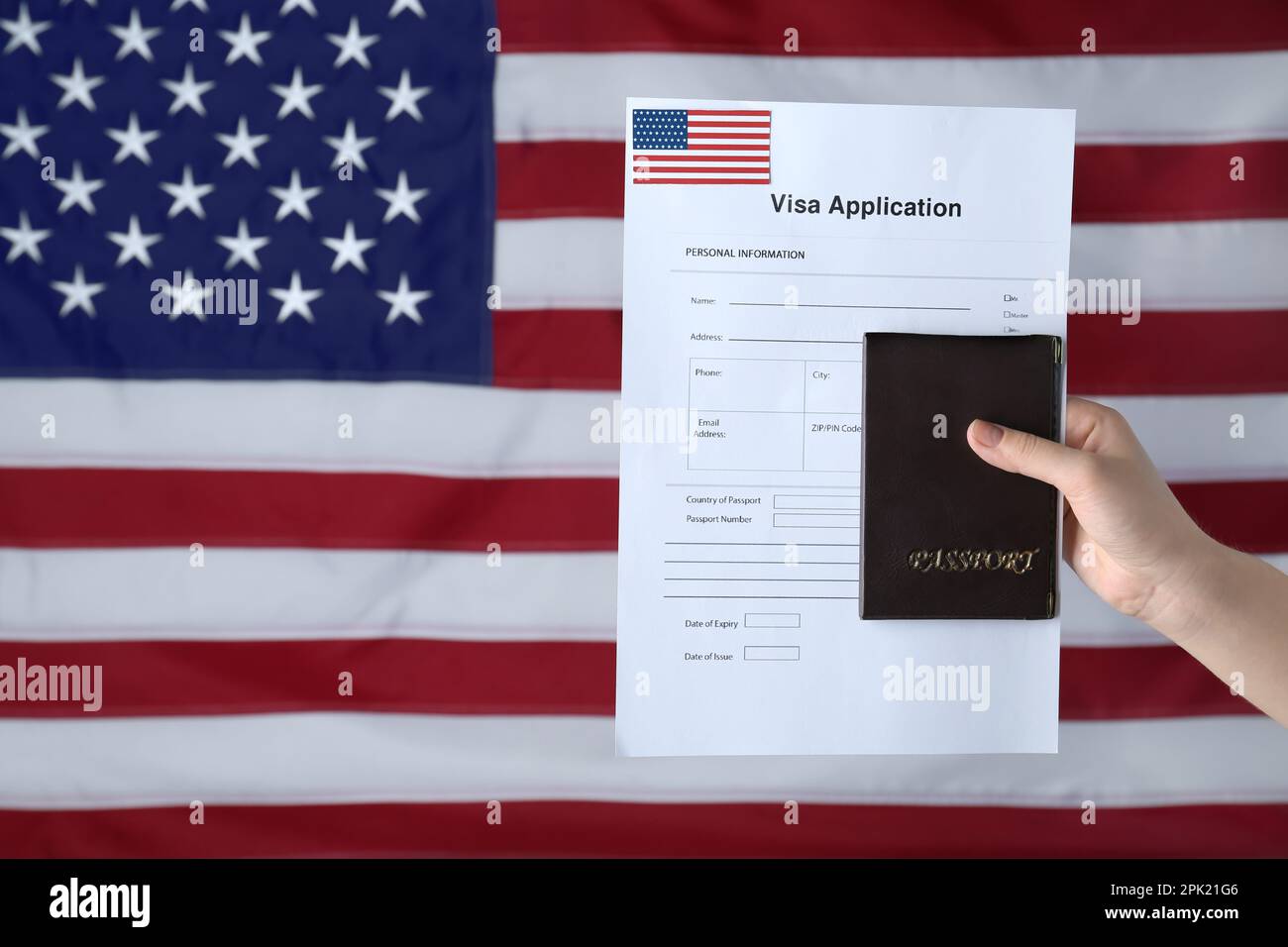 Woman holding visa application form and passport against American flag ...