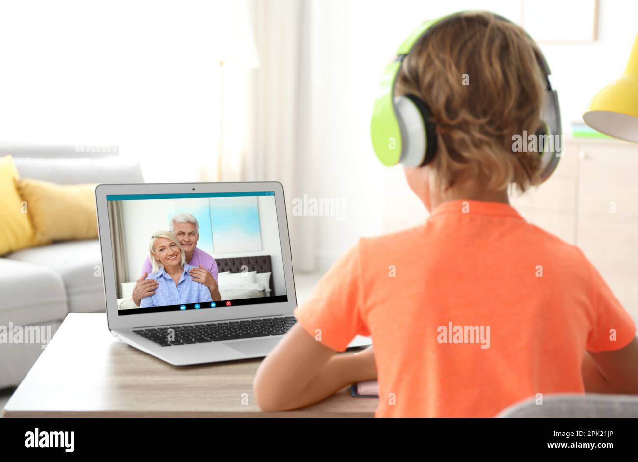 Little boy talking with his grandparents via videocall application at ...