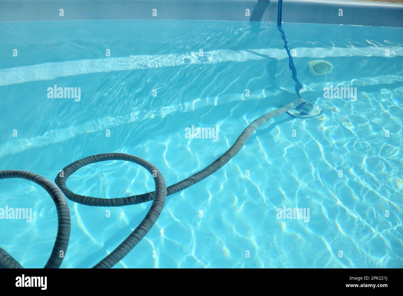 Cleaning outdoor swimming pool with underwater vacuum Stock Photo - Alamy