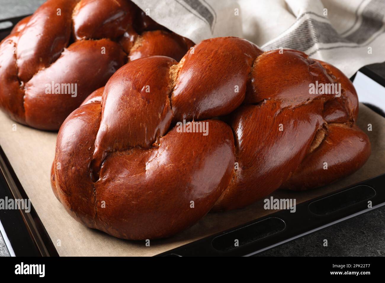Homemade braided bread on grey table, closeup. Traditional challah ...
