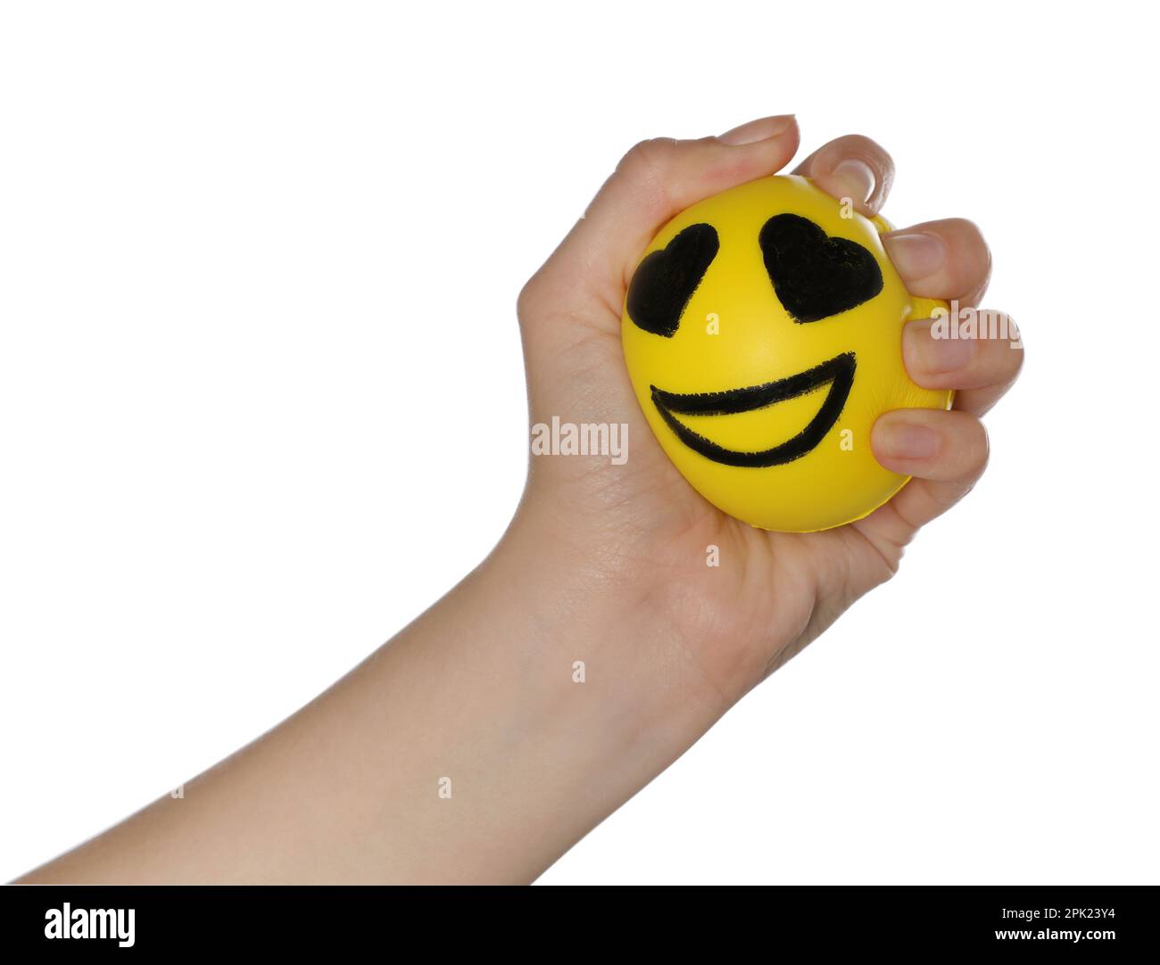 Woman squeezing antistress ball with funny face on white background ...