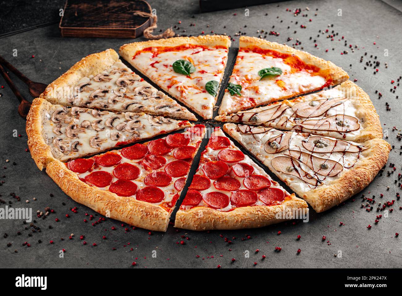 Big assorted pizza with variety of toppings Stock Photo - Alamy