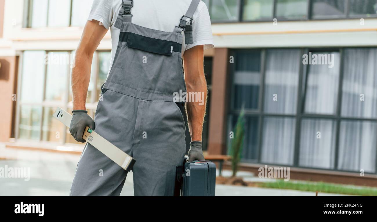 Ready for work. Young man in uniform at construction at daytime Stock ...