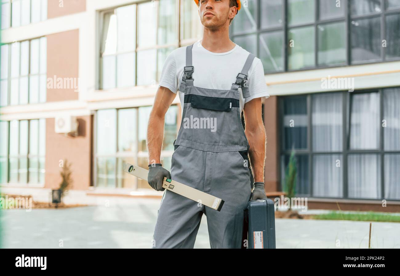 Ready for work. Young man in uniform at construction at daytime Stock ...