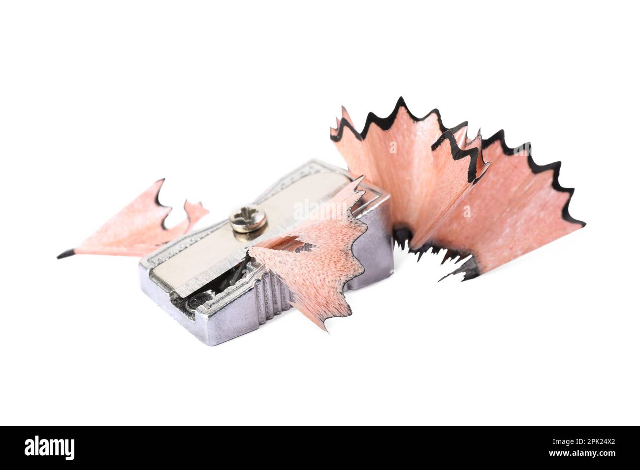 Metal sharpener with pencil shavings on white background Stock Photo ...