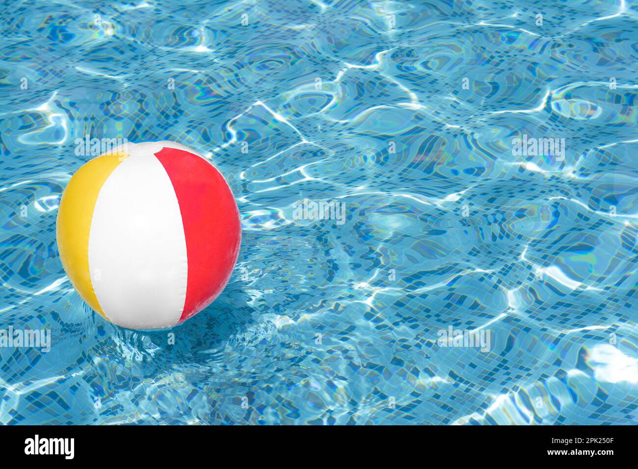 Inflatable beach ball floating in swimming pool, space for text Stock ...