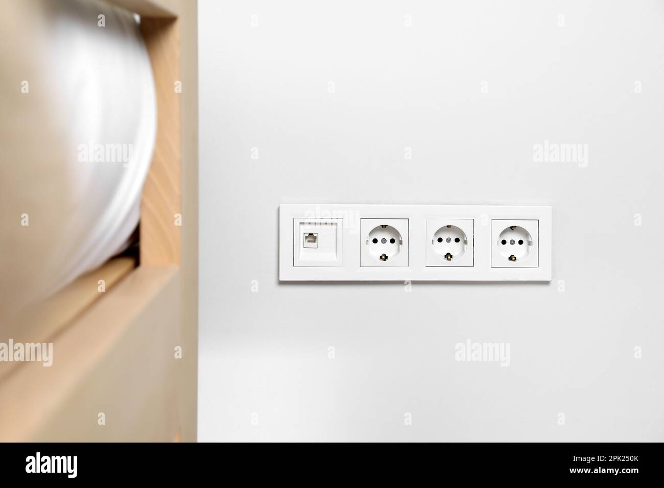 Power sockets on white wall indoors. Electrical supply Stock Photo - Alamy