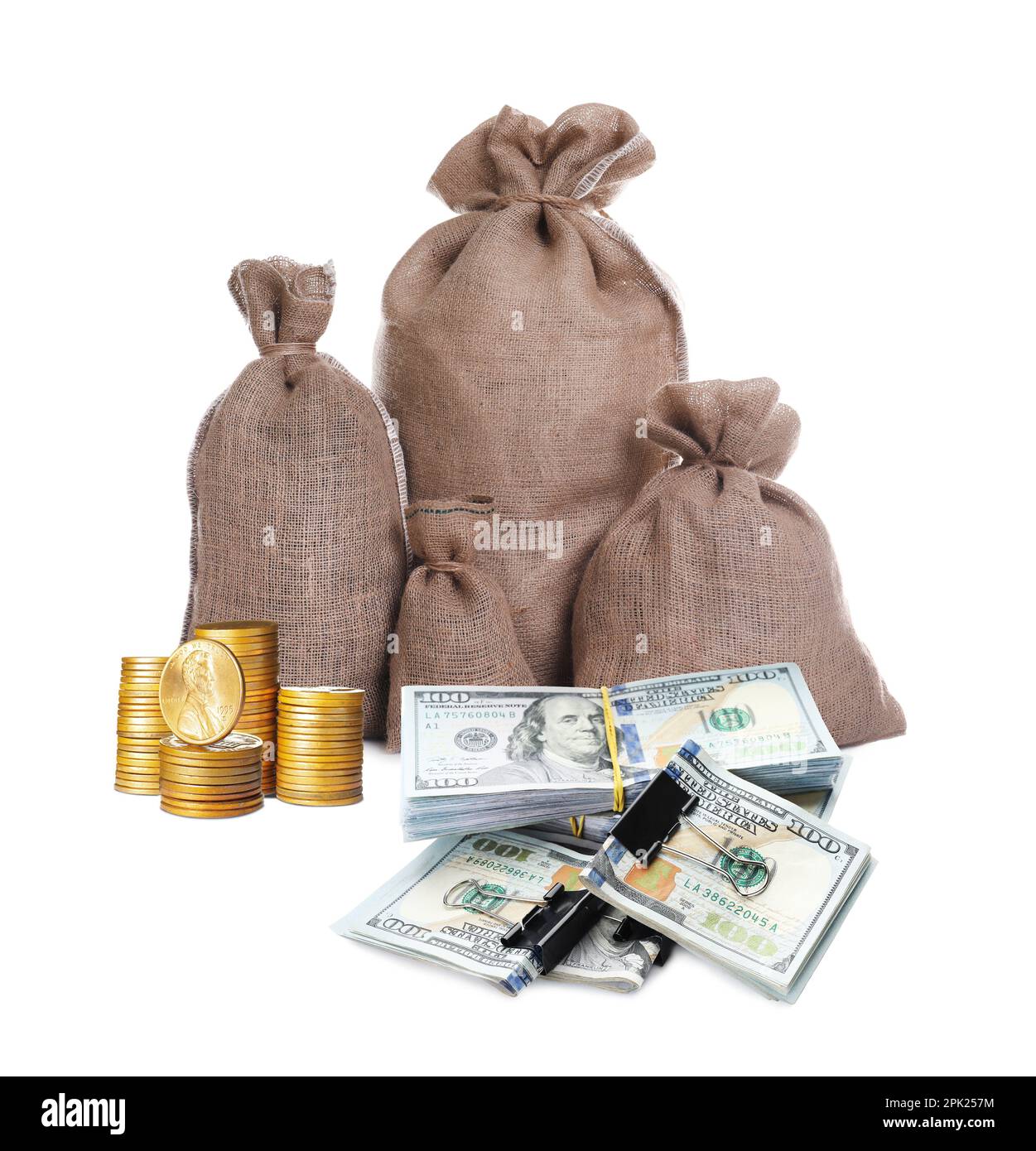 Stacked coins, dollar banknotes and sack full of money on white ...
