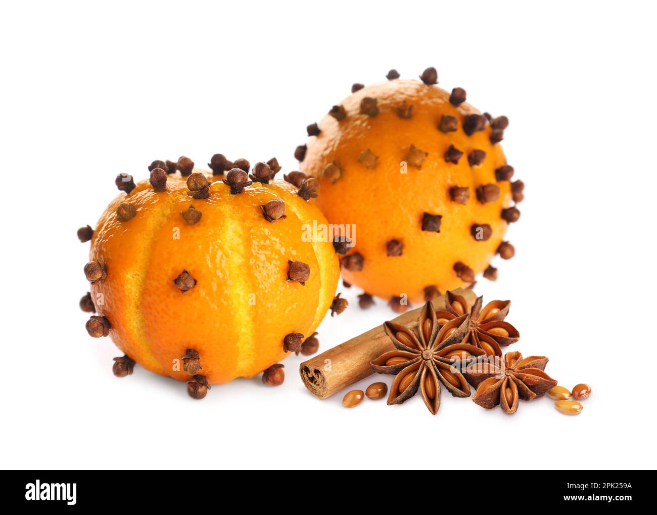 Fresh ripe pomander balls, cloves, anise and cinnamon on white ...