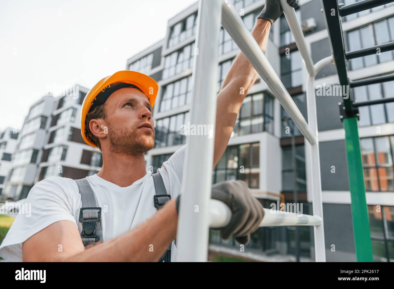 Big project. Young man working in uniform at construction at daytime ...