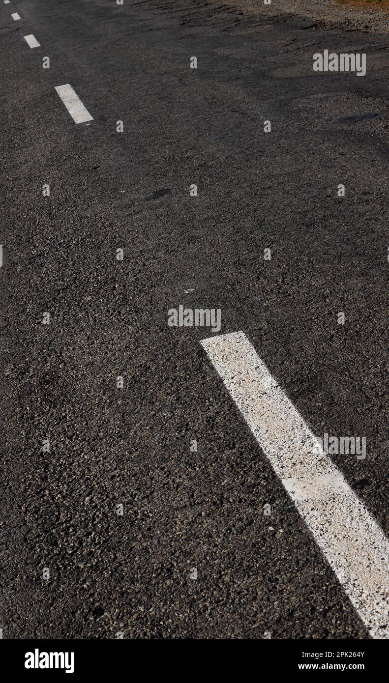 White dotted line on city asphalt road background Stock Photo - Alamy