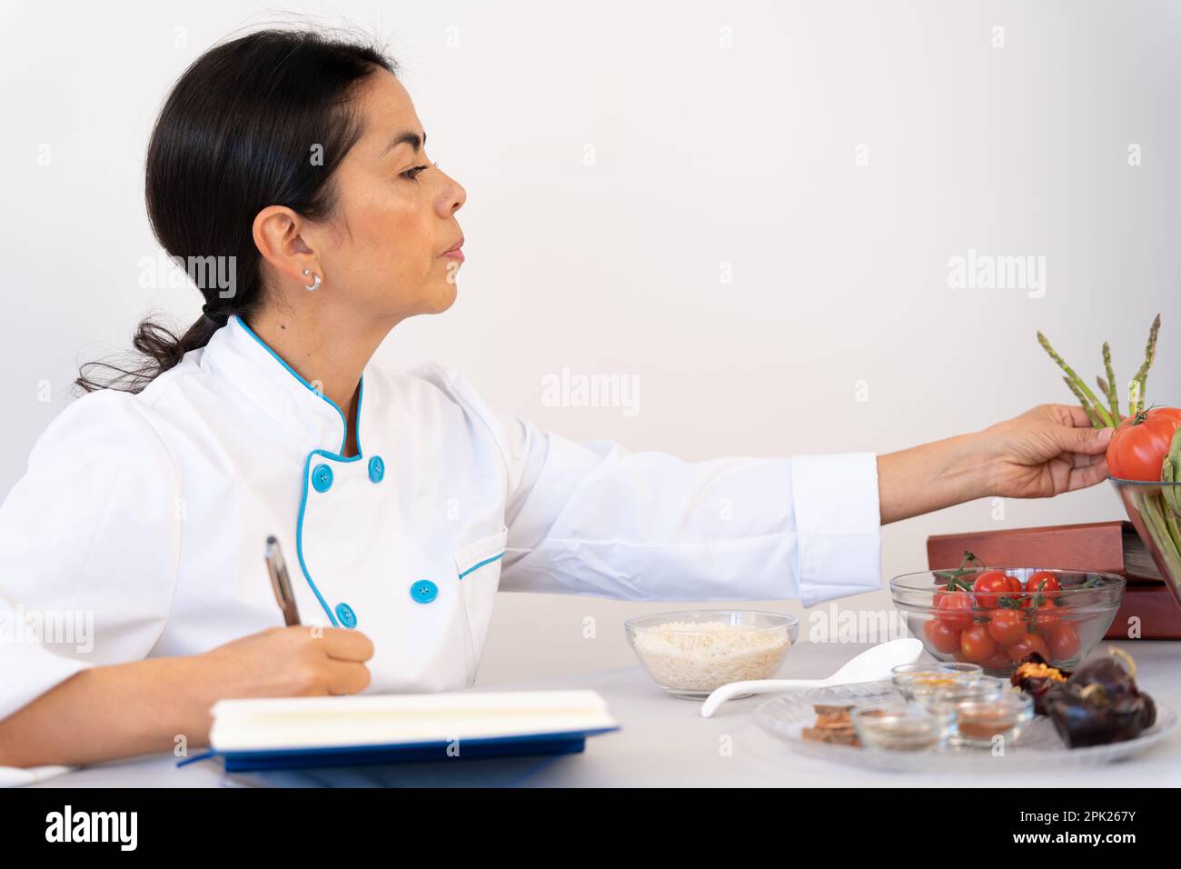 Chef taking notes in the kitchen Stock Photo - Alamy