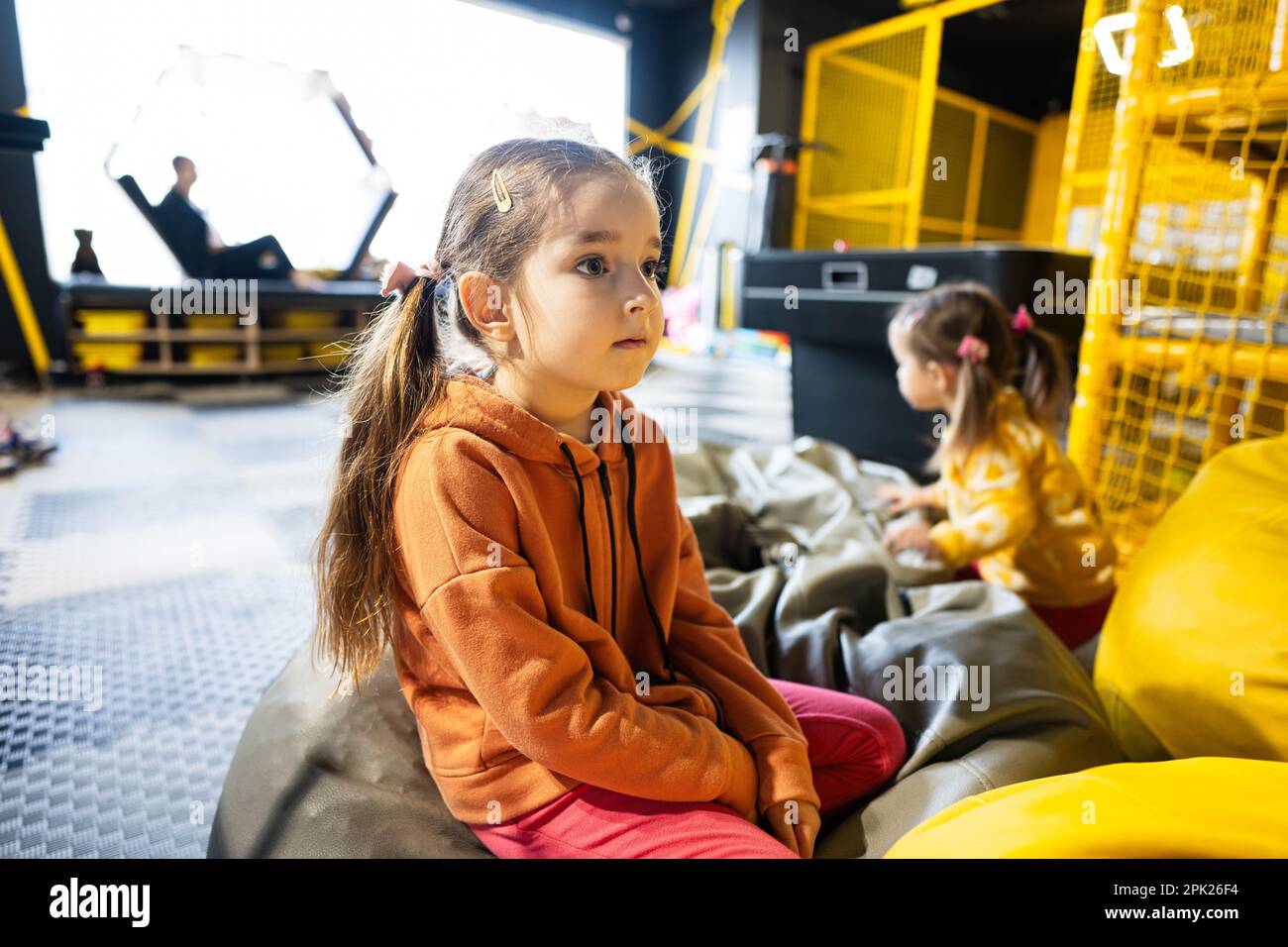 Two sisters playing at kids play center Stock Photo - Alamy