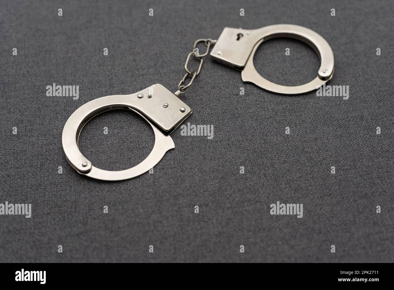Closed metal handcuffs Crime concept Stock Photo - Alamy
