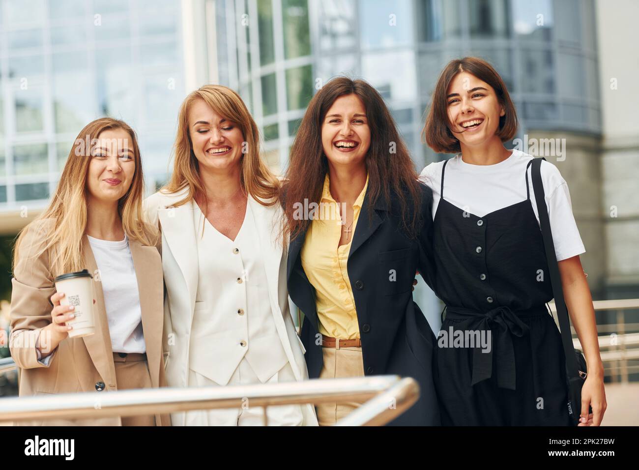 Women in formal wear is outdoors in the city together Stock Photo - Alamy