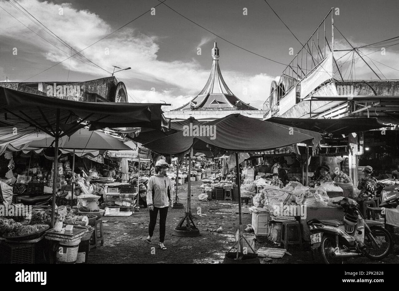 A women shopper wearing a crash helmet and face mask walks through an ...