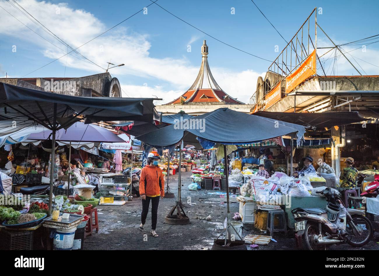A women shopper wearing a crash helmet and face mask walks through an ...