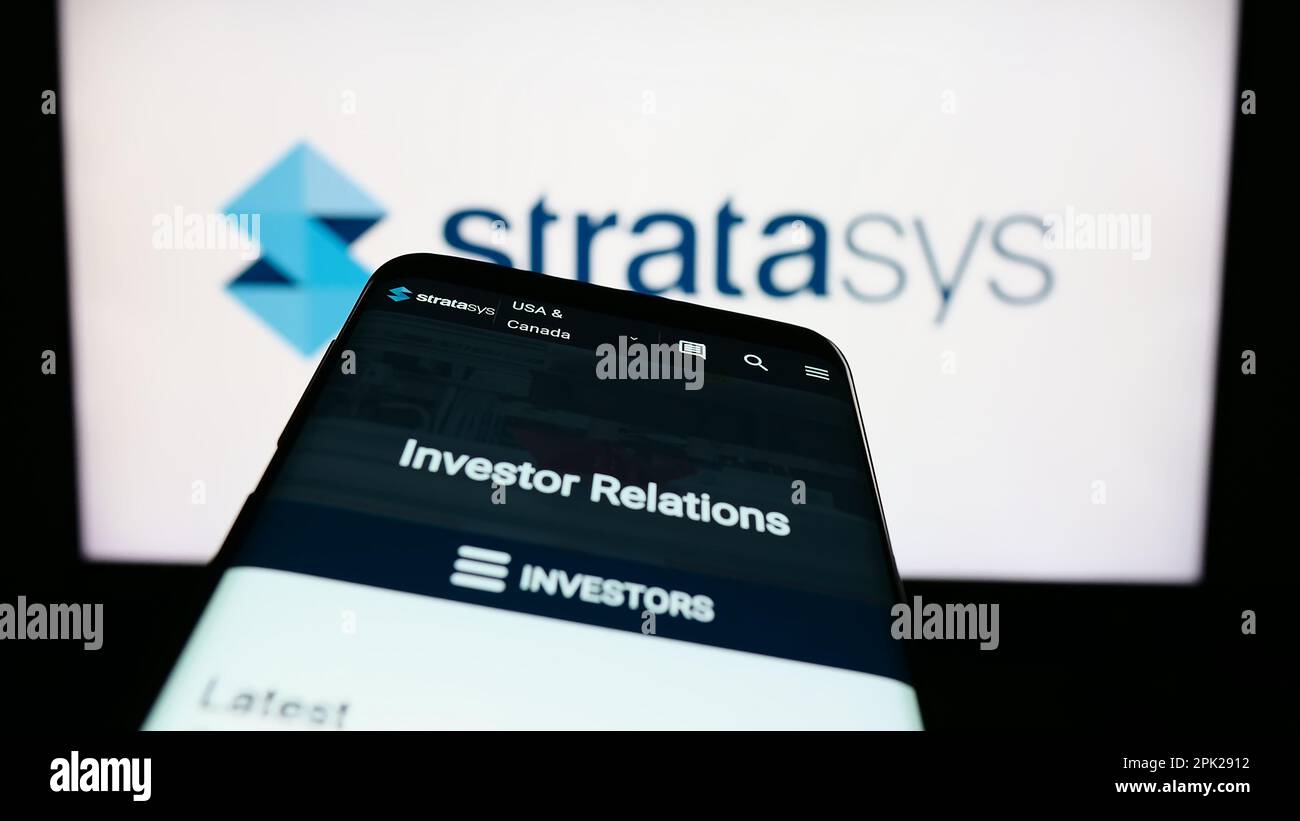 Smartphone with webpage of 3D printing company Stratasys Ltd. on screen ...