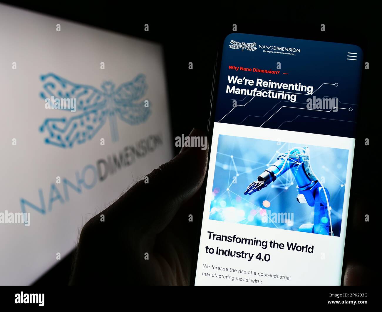 Person holding smartphone with webpage of company Nano Dimension ...