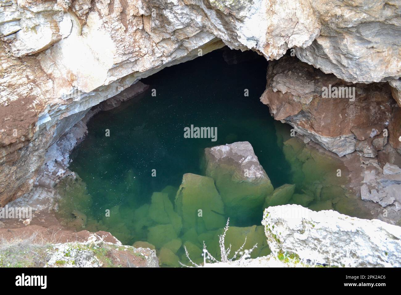A natural water well formed between the rocks Stock Photo - Alamy