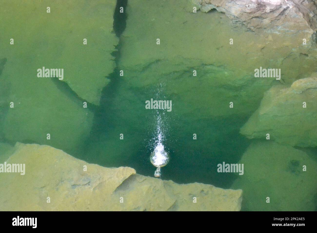 The unique image and ripple that occurs when an object is thrown into ...