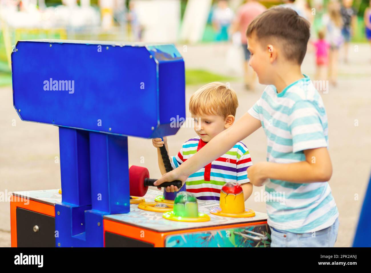 Children playing whack a mole arcade game at an amusement park Stock ...