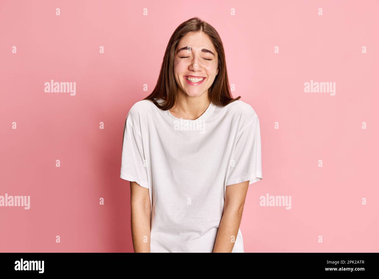 Happiness. Portrait of young positive, beautiful girl in white t-shirt ...