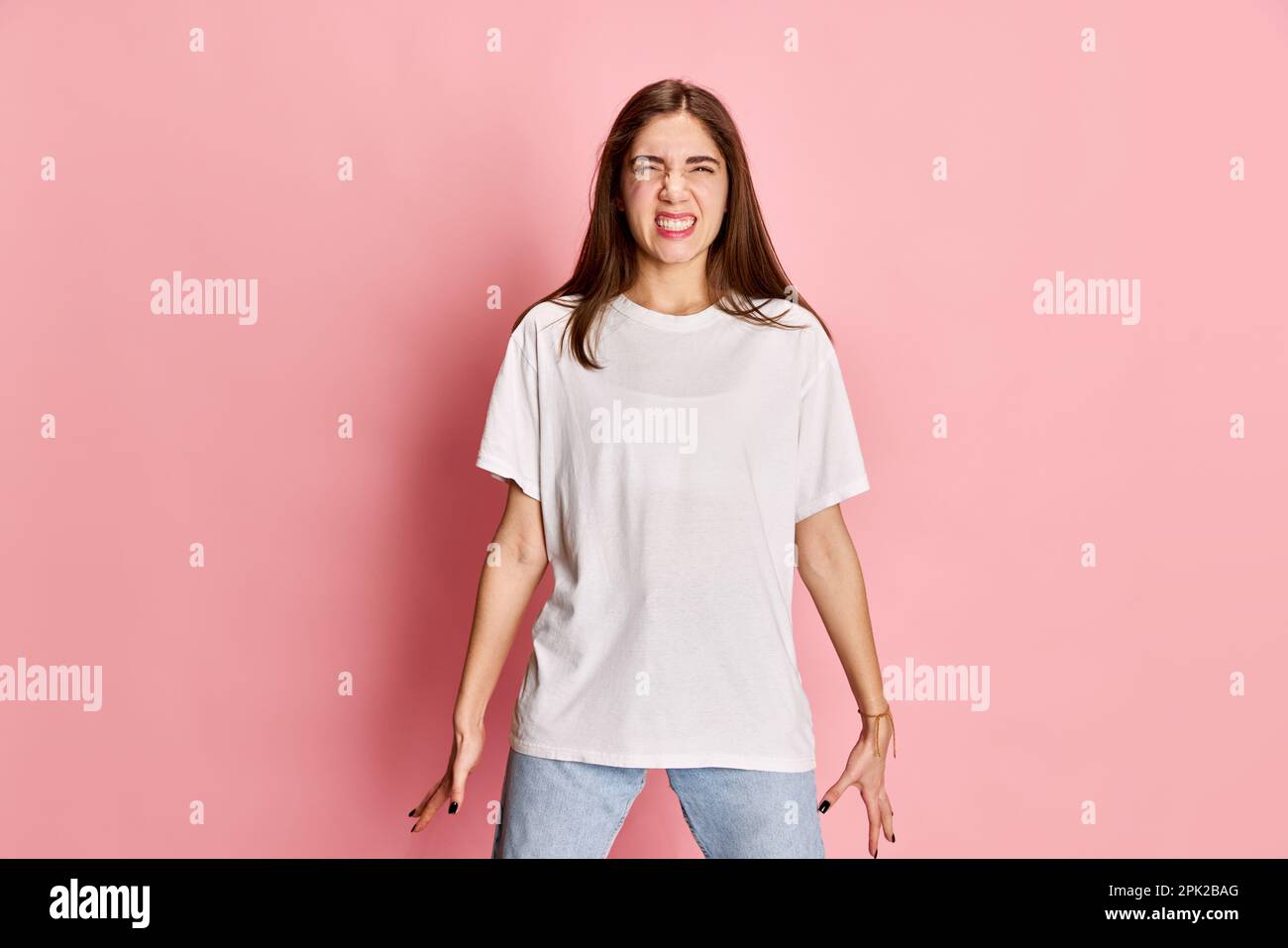 Portrait of young irritated girl in casual clothes emotionally showing ...