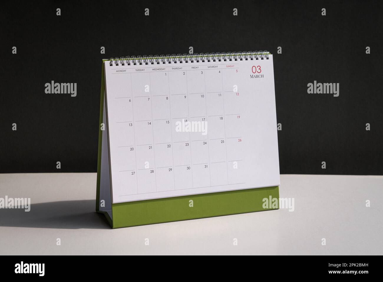 Standing desk calendar March on white table and black background Stock ...