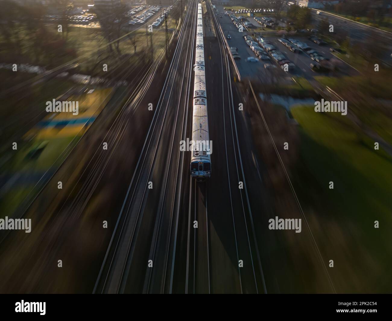 This aerial image reveals a railway line entering a sprawling cityscape ...