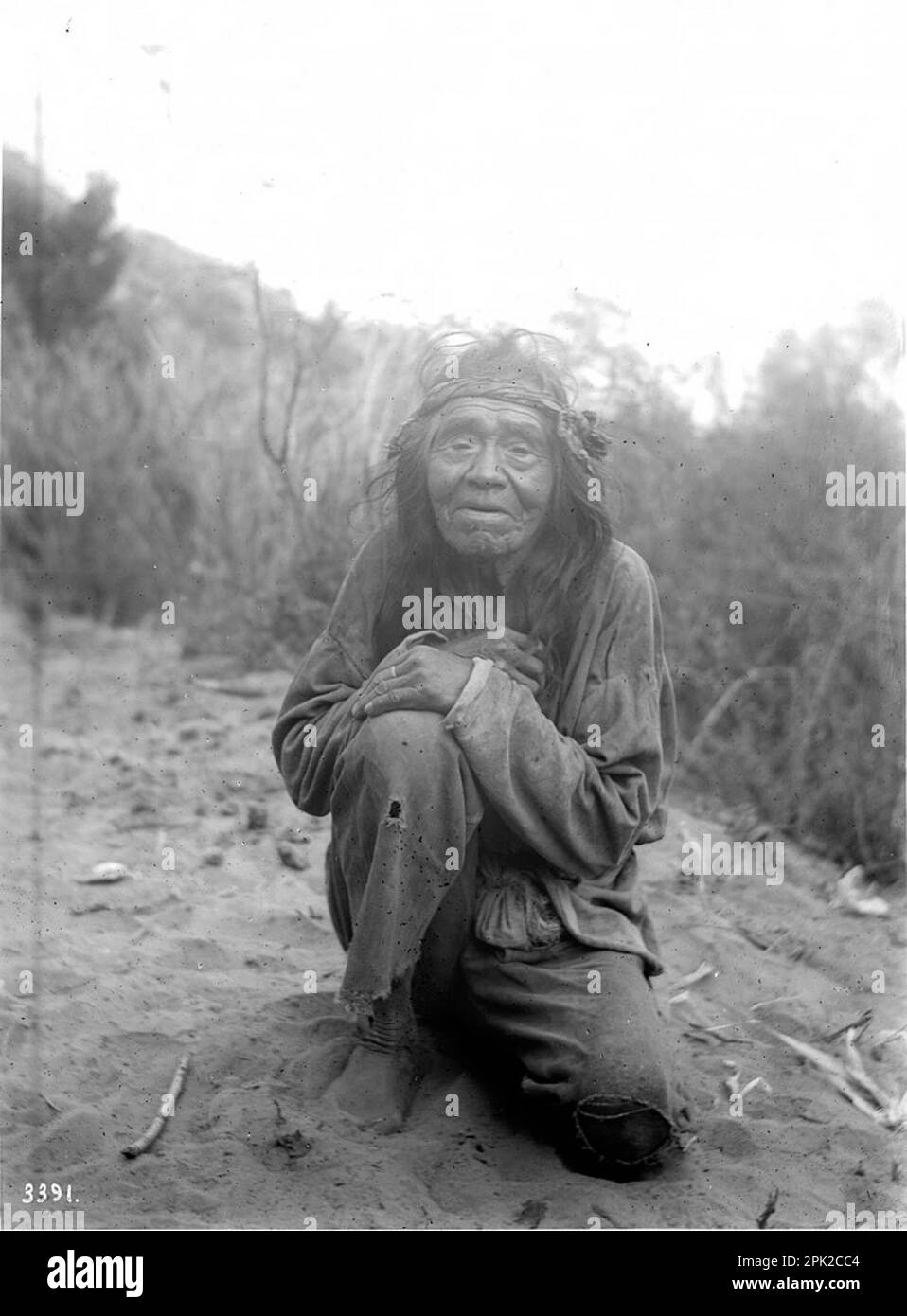 Old Havasupai Indian man crouching on the ground, ca.1900 Stock Photo ...