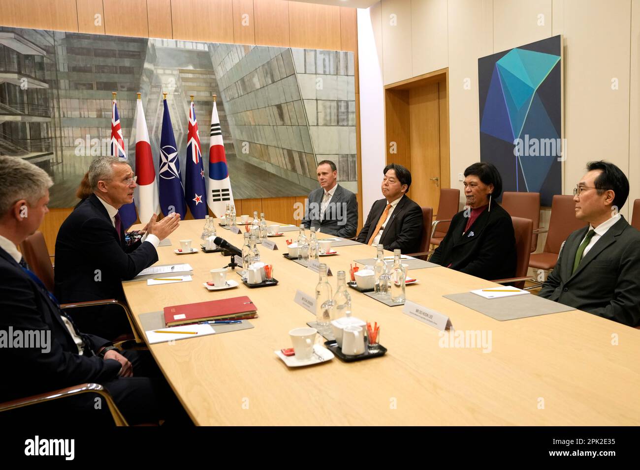 NATO Secretary General Jens Stoltenberg, second left, speaks with from ...