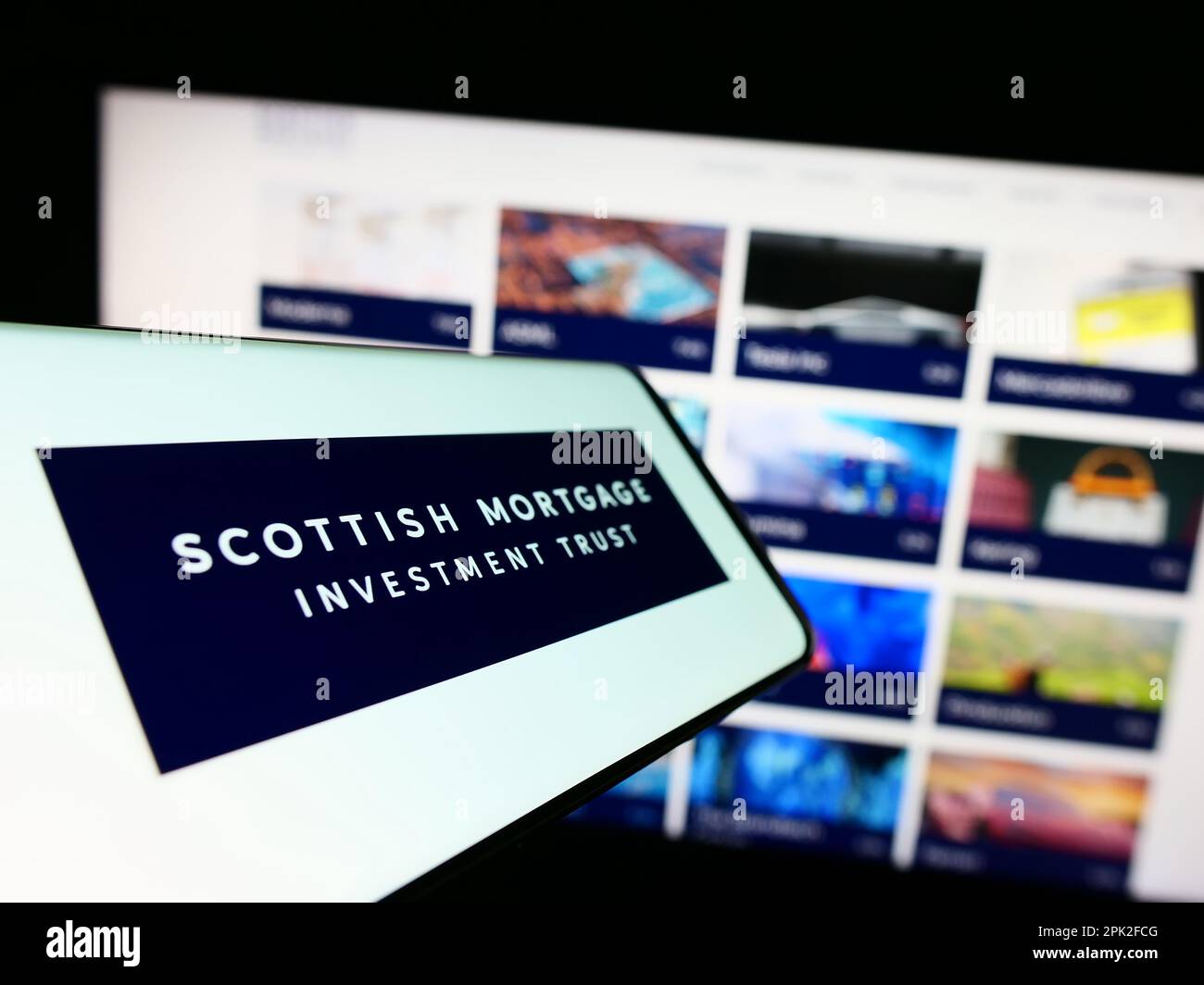 Mobile phone with logo of Scottish Mortgage Investment Trust plc on ...