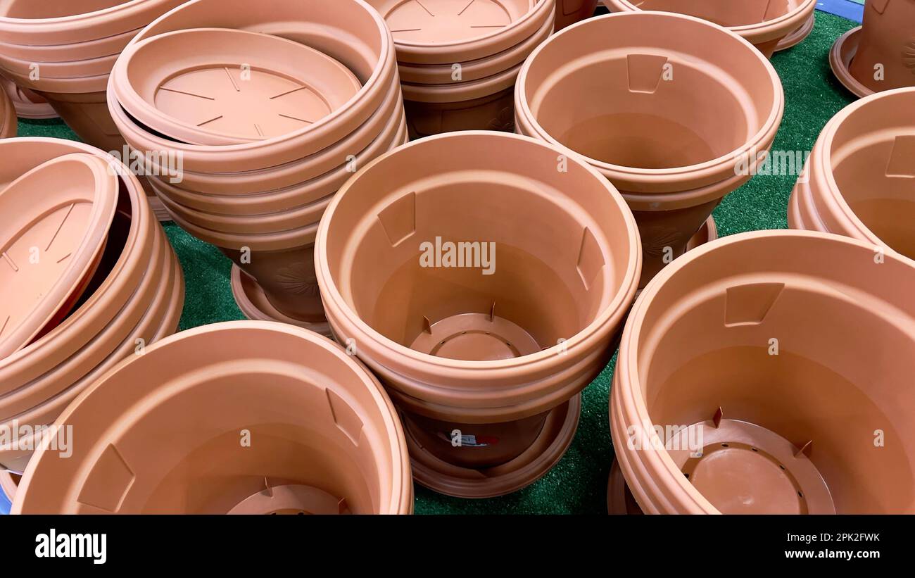 Close-up of empty flower pots in a store or greenhouse. Colorful pots ...