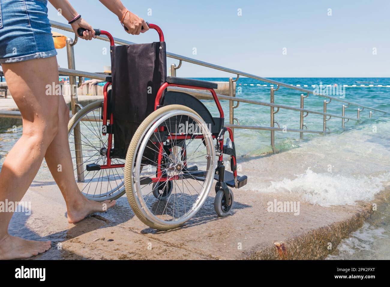 Accessible beach with wheelchair with ramp for persons with disability ...