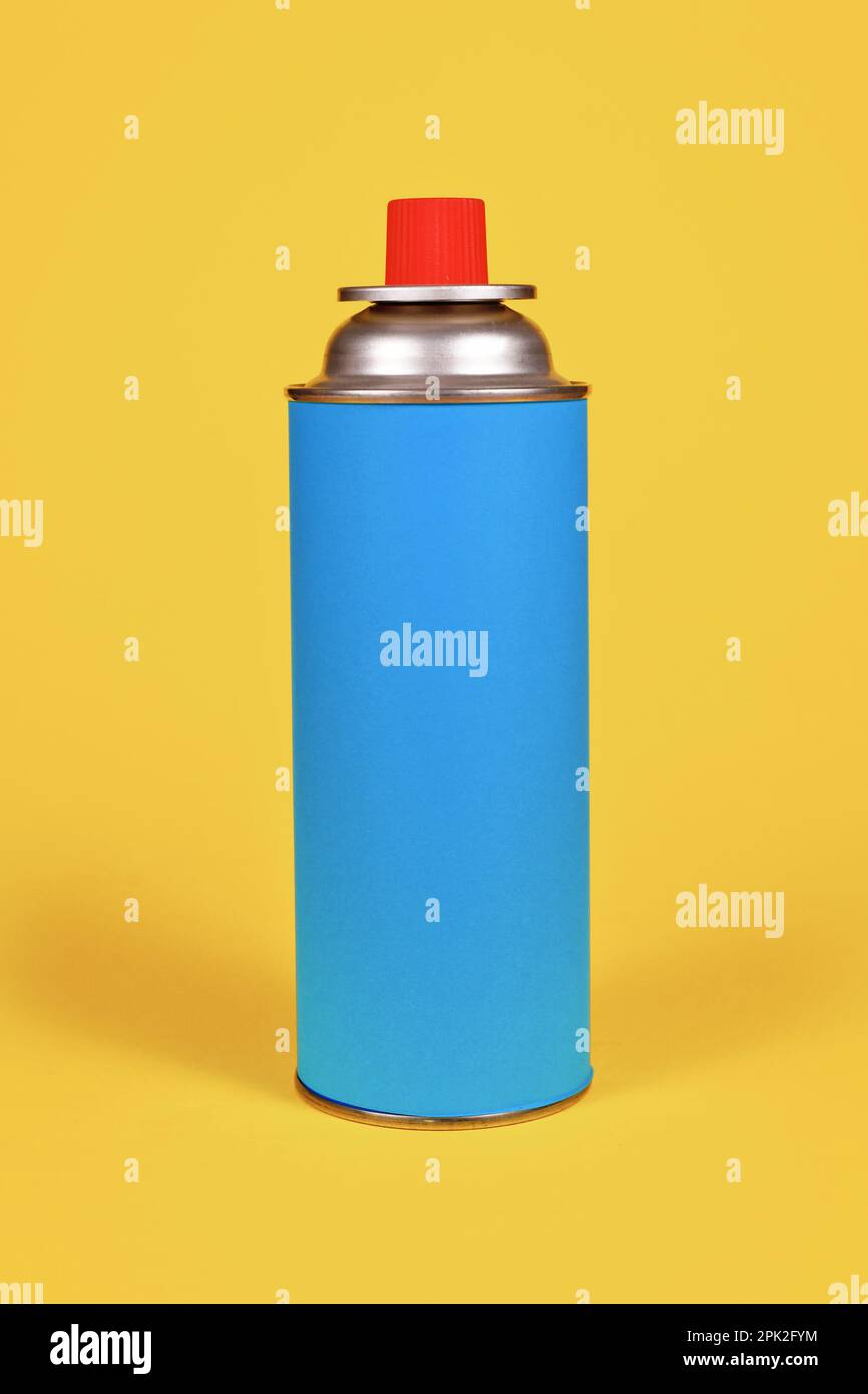 Blue cartridge bottle on yellow background Stock Photo - Alamy