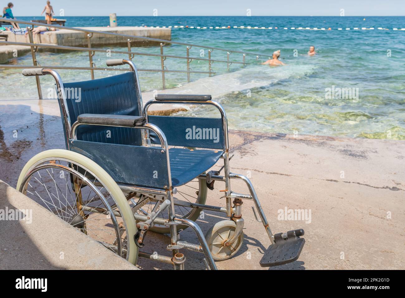 Accessible beach with wheelchair with ramp for persons with disability ...