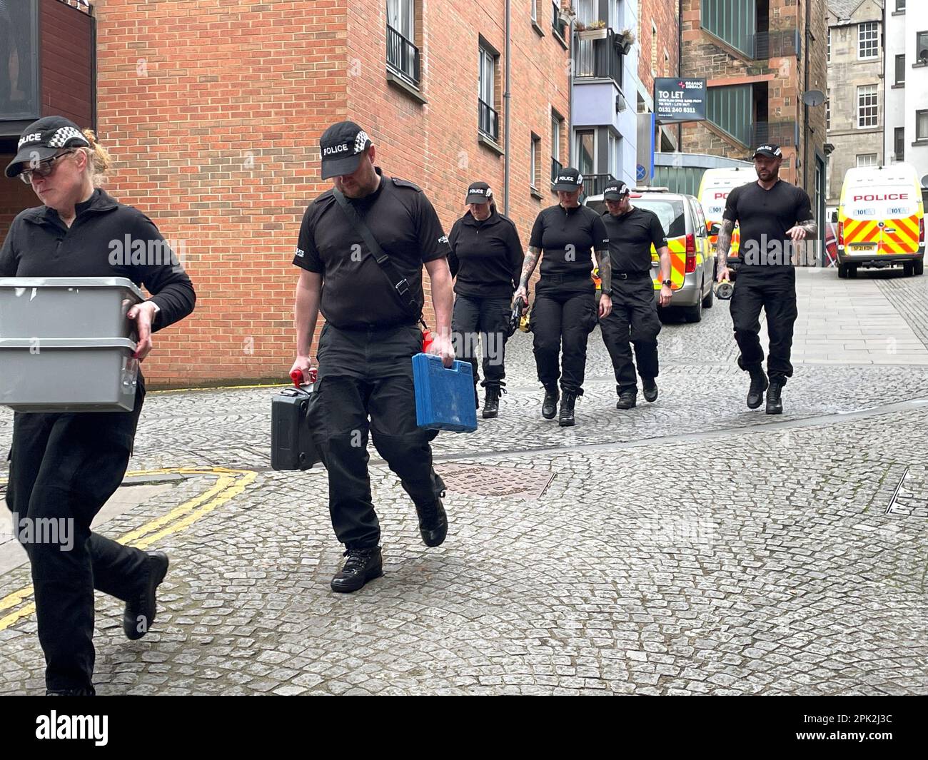 Officers from Police Scotland outside the headquarters of the Scottish ...