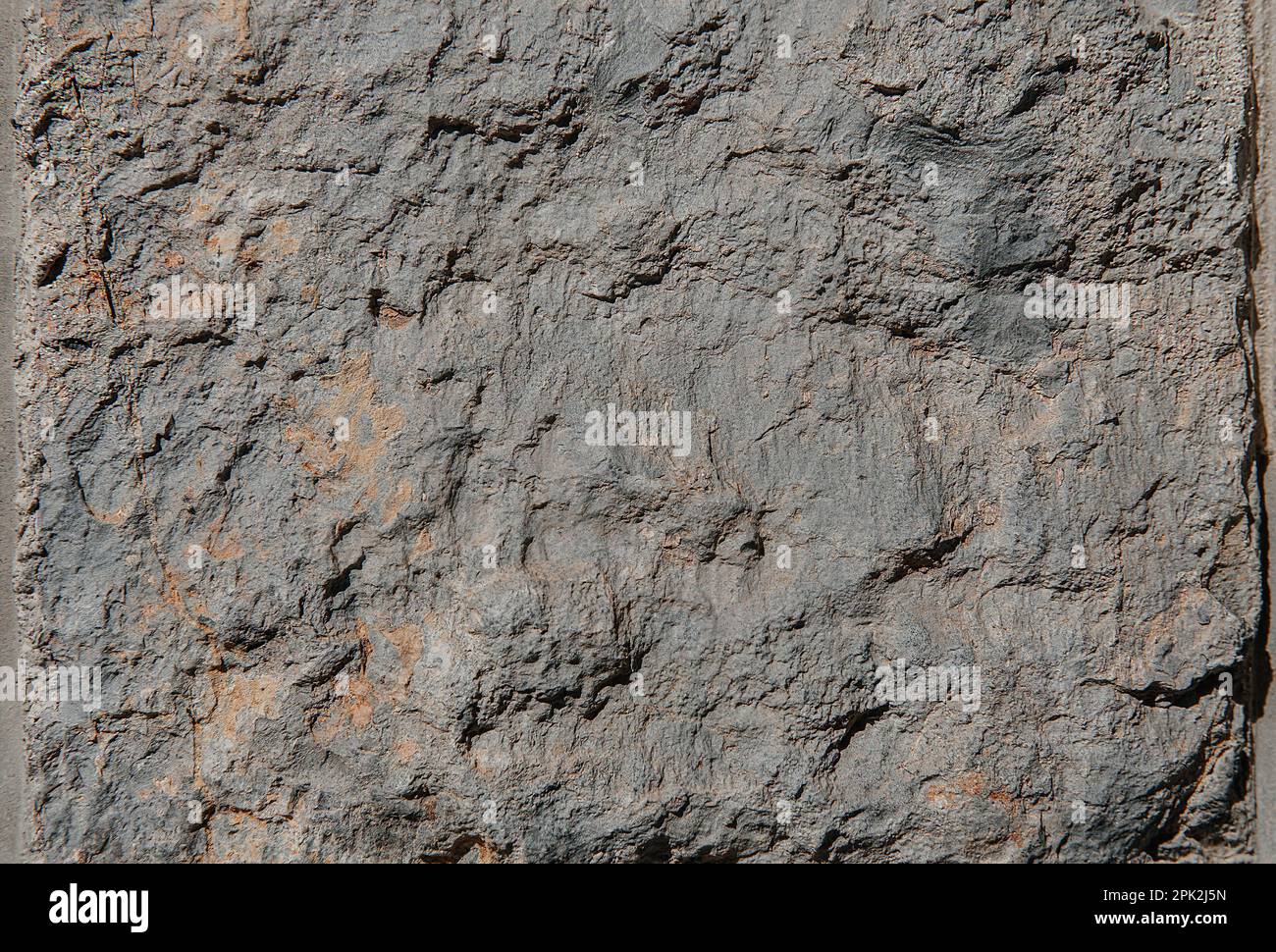 Stone texture of an old rough building wall with cracks, reliefs, plots ...