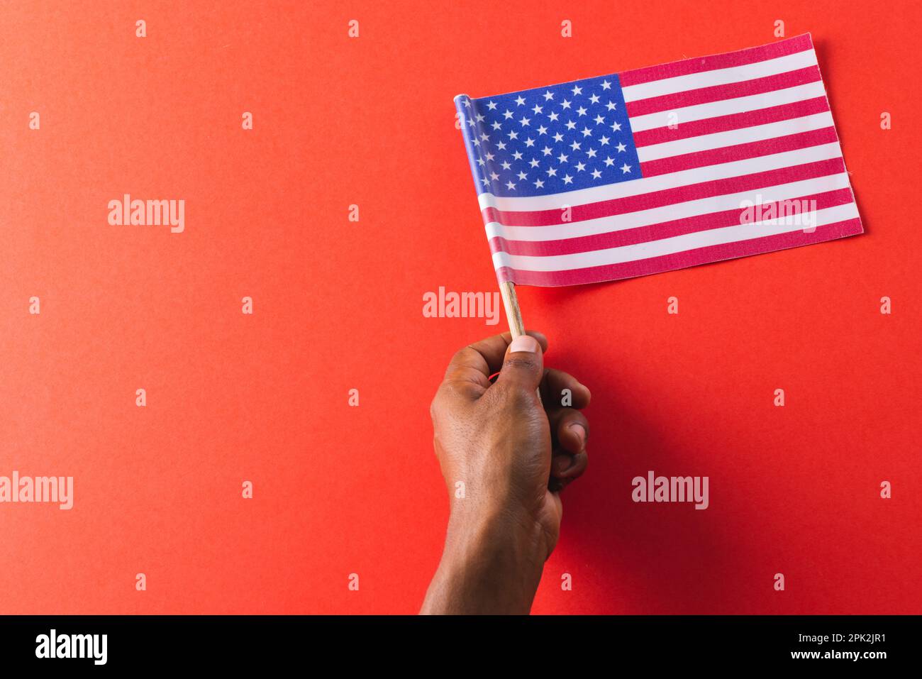 Hand of biracial man holding flag of united states of america with copy ...