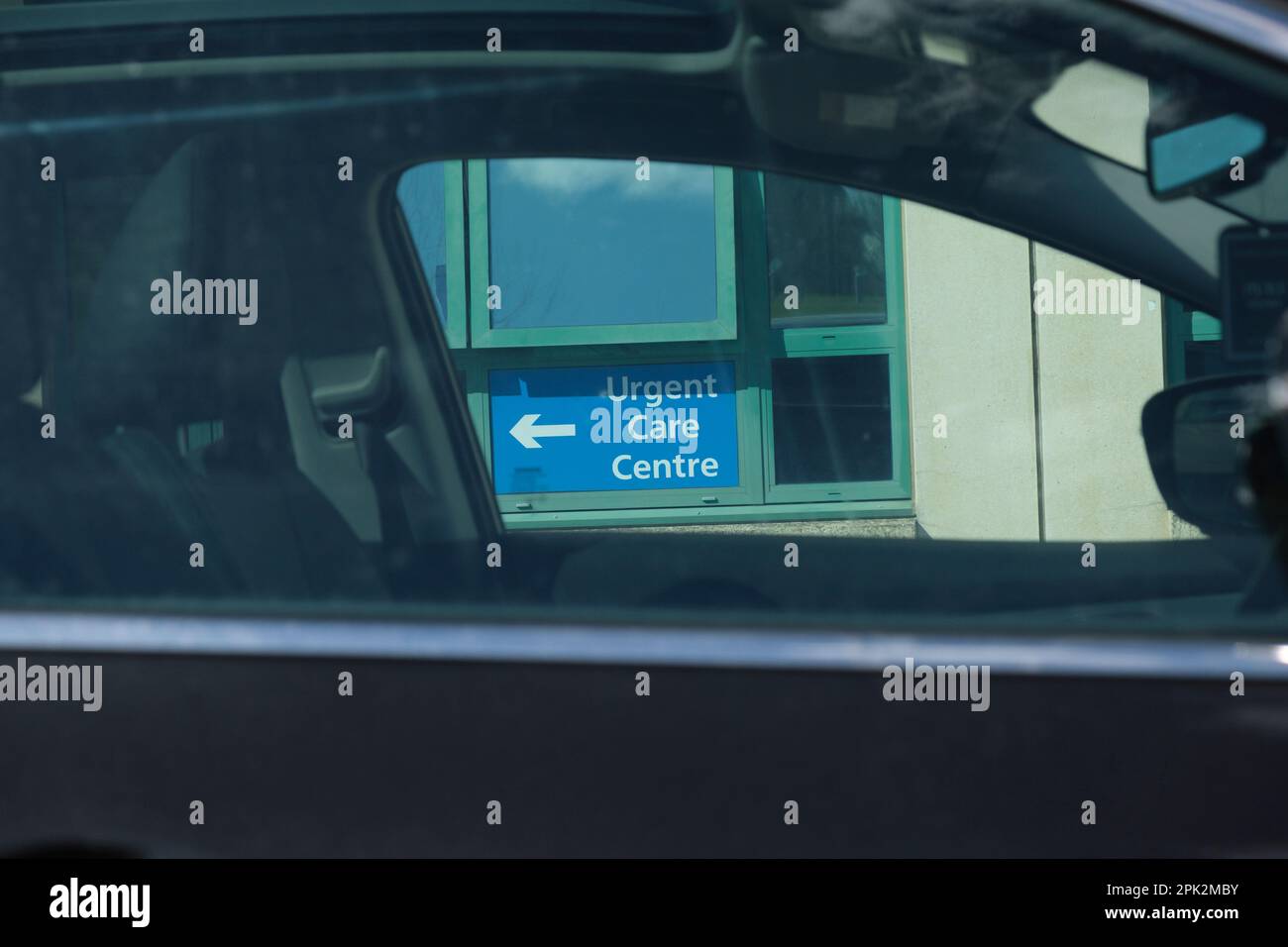 View from a parked car through the window to sings outside a local ...