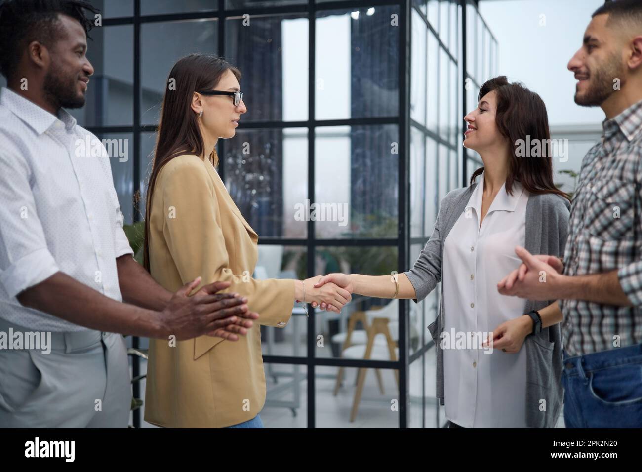 Two professional business people shaking hands in an office lobby Stock ...
