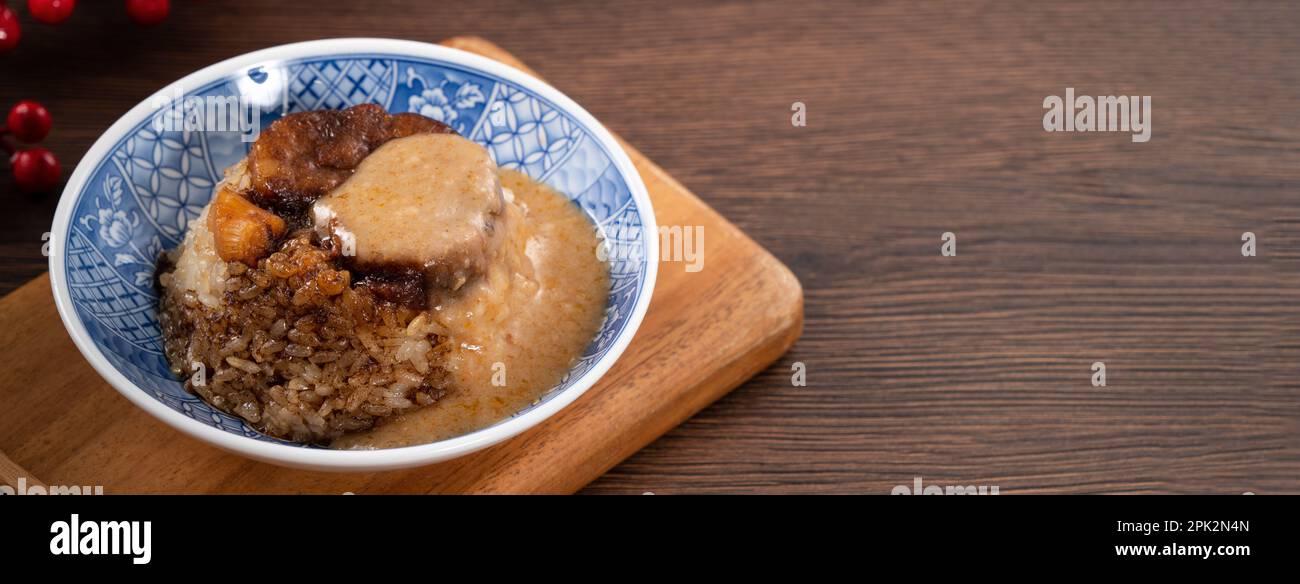 Migao, tube rice cake, rice pudding in a bowl topped with minced pork ...