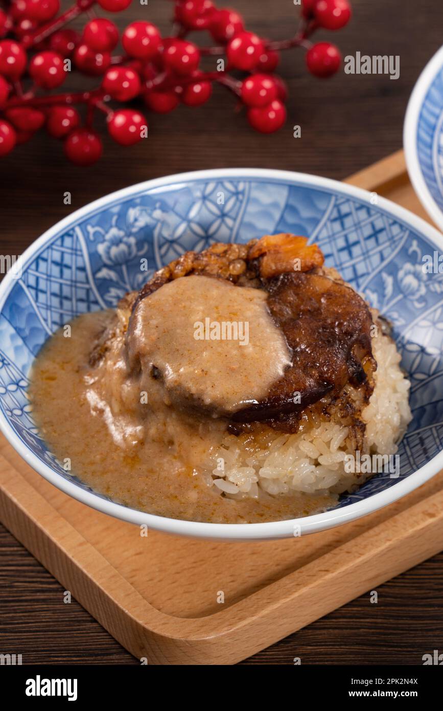 Migao, tube rice cake, rice pudding in a bowl topped with minced pork ...