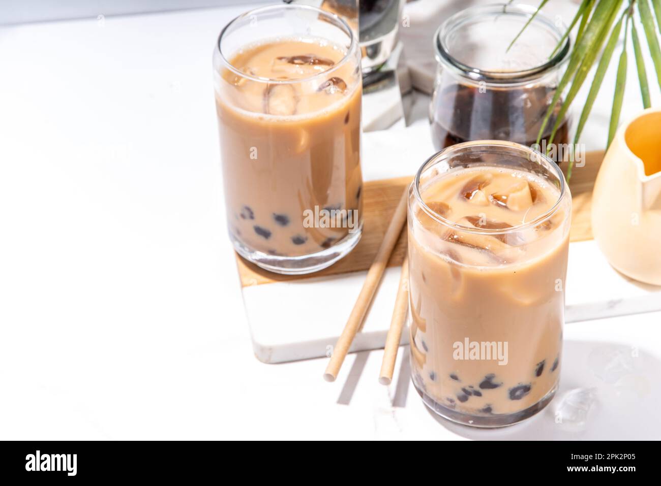 Iced tapioca coffee latte or boba pearl bubbles milk tea, asian trendy cold coffee drink with ...