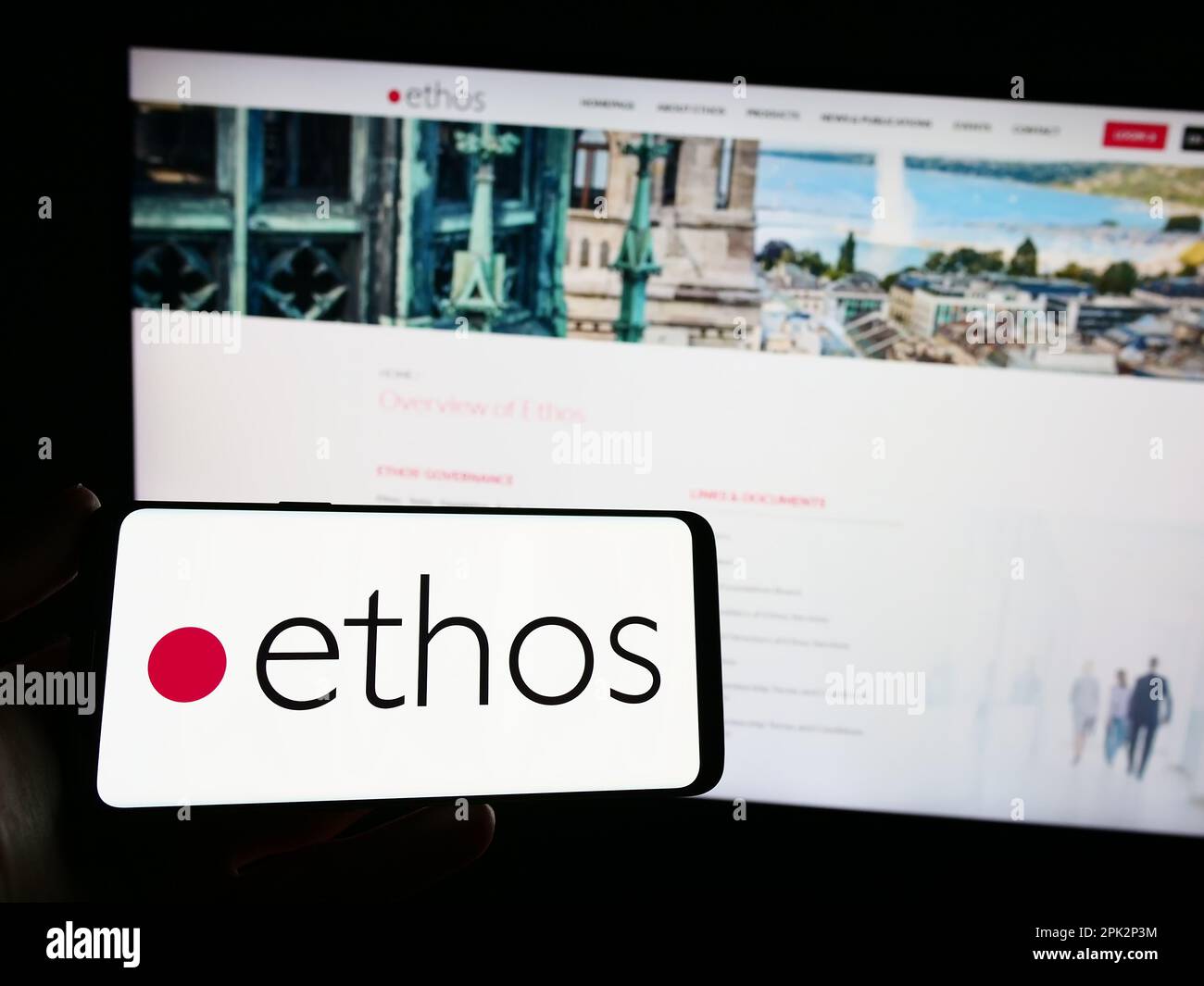 Person holding smartphone with logo of Swiss financial institution ...