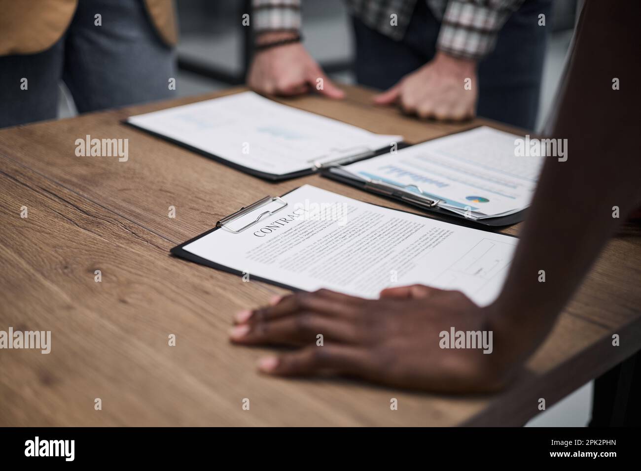 Contract with hand on table signs business transaction Stock Photo - Alamy