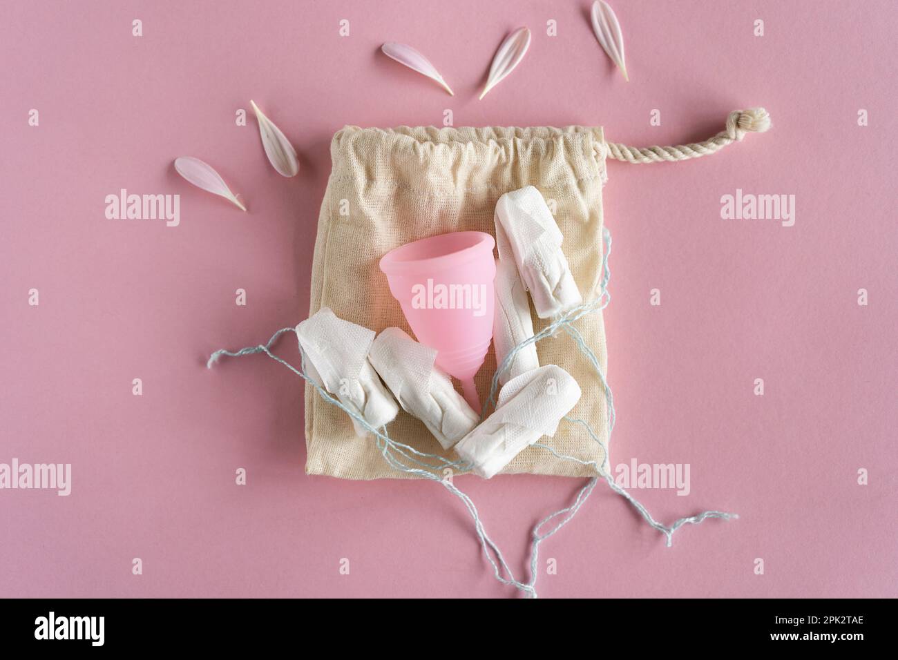 Tampons and menstrual cup on pink background Stock Photo - Alamy